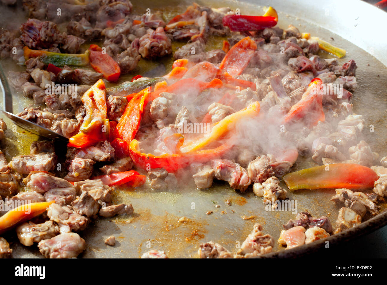 Paella from Spain first steps cooking big pan Stock Photo - Alamy