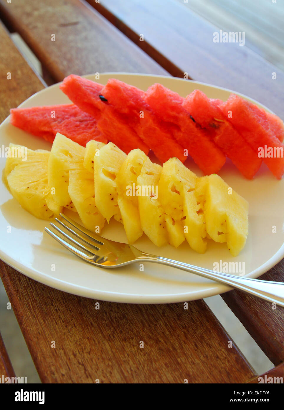 Watermelon and pineapple on dish with fork Stock Photo - Alamy