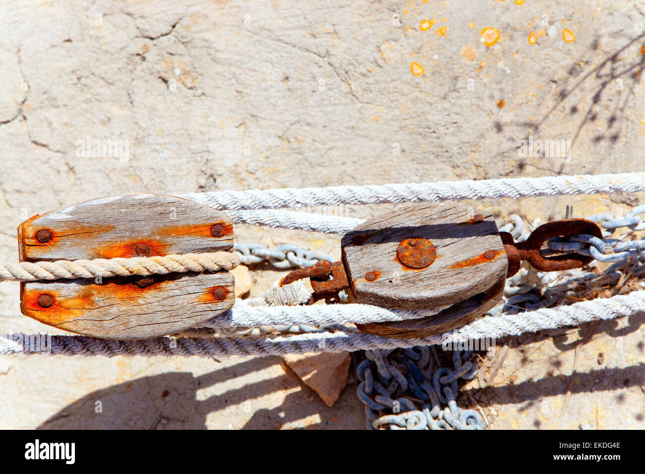 Aged rusted wooden pulley in Mediterrantan port Stock Photo - Alamy