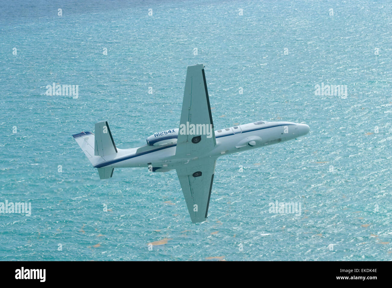 A CBP Air Unit Citation Jet maneuvers sharply over U.S. waters near a ...