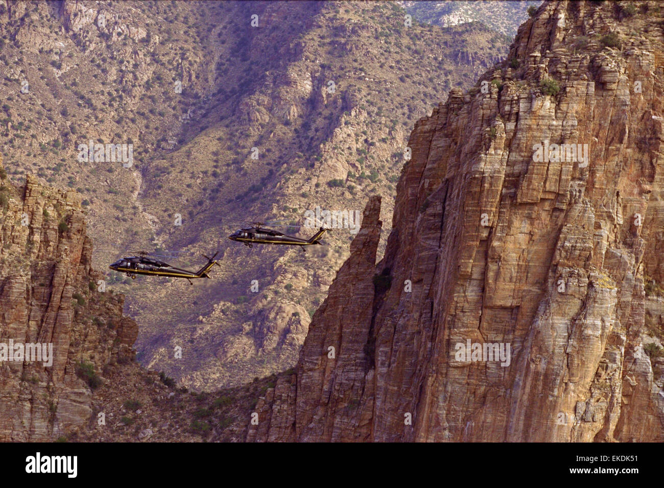 Two CBP Air Unit UH-60 Blackhawk helicopters patrol the airspace over ...