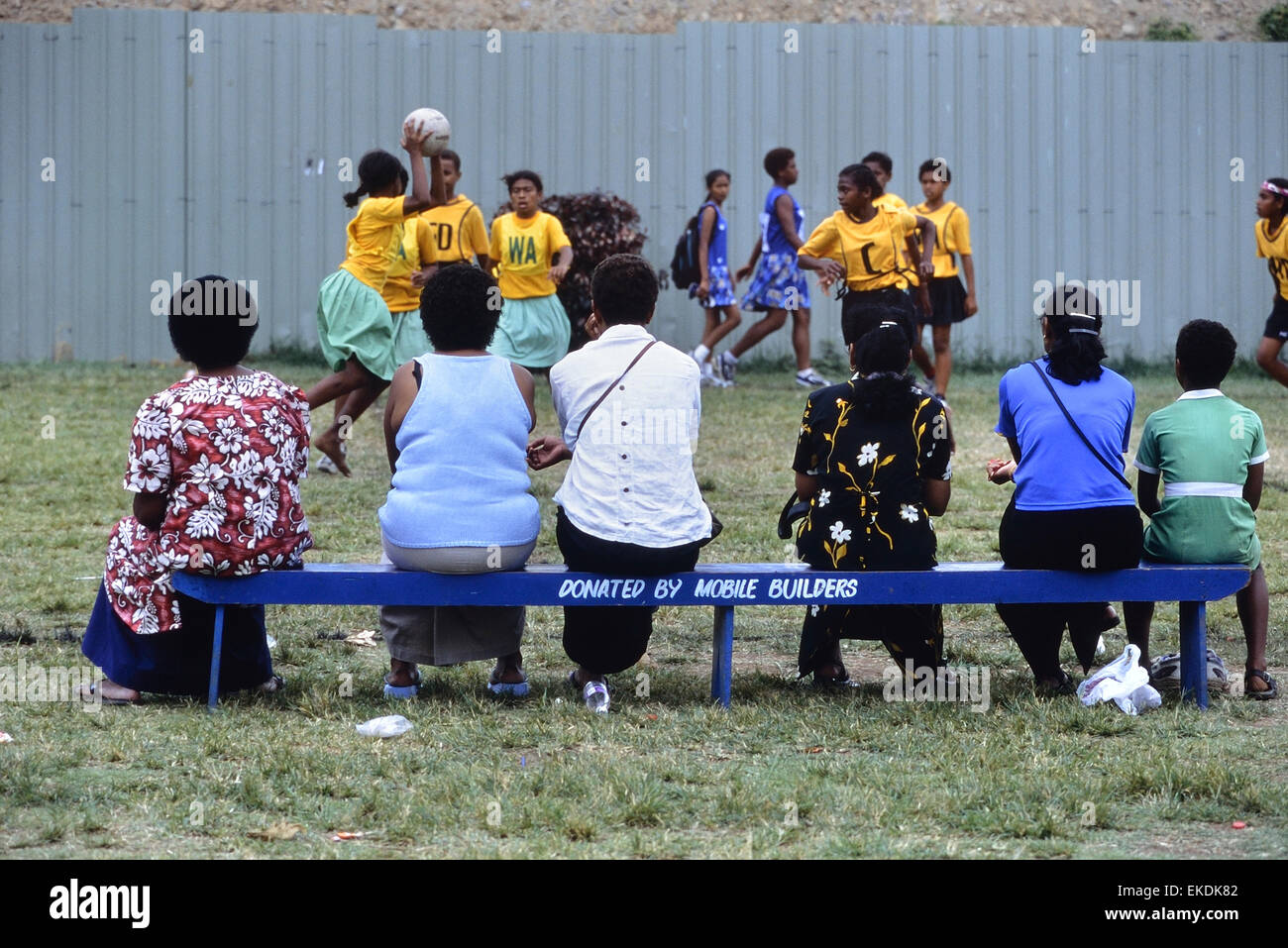School children and parents watching a girls netball match at Churchill ...
