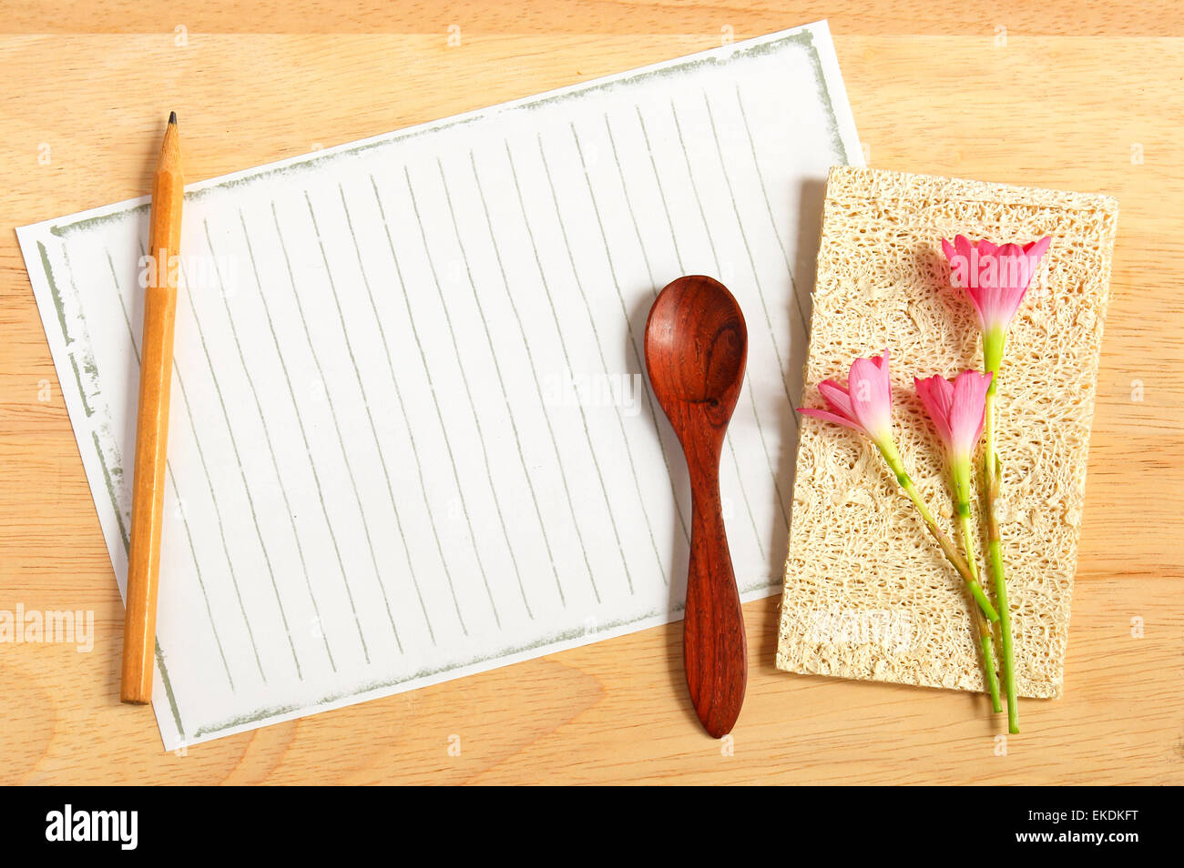 Pencil and spoon with paper on wooden background Stock Photo - Alamy