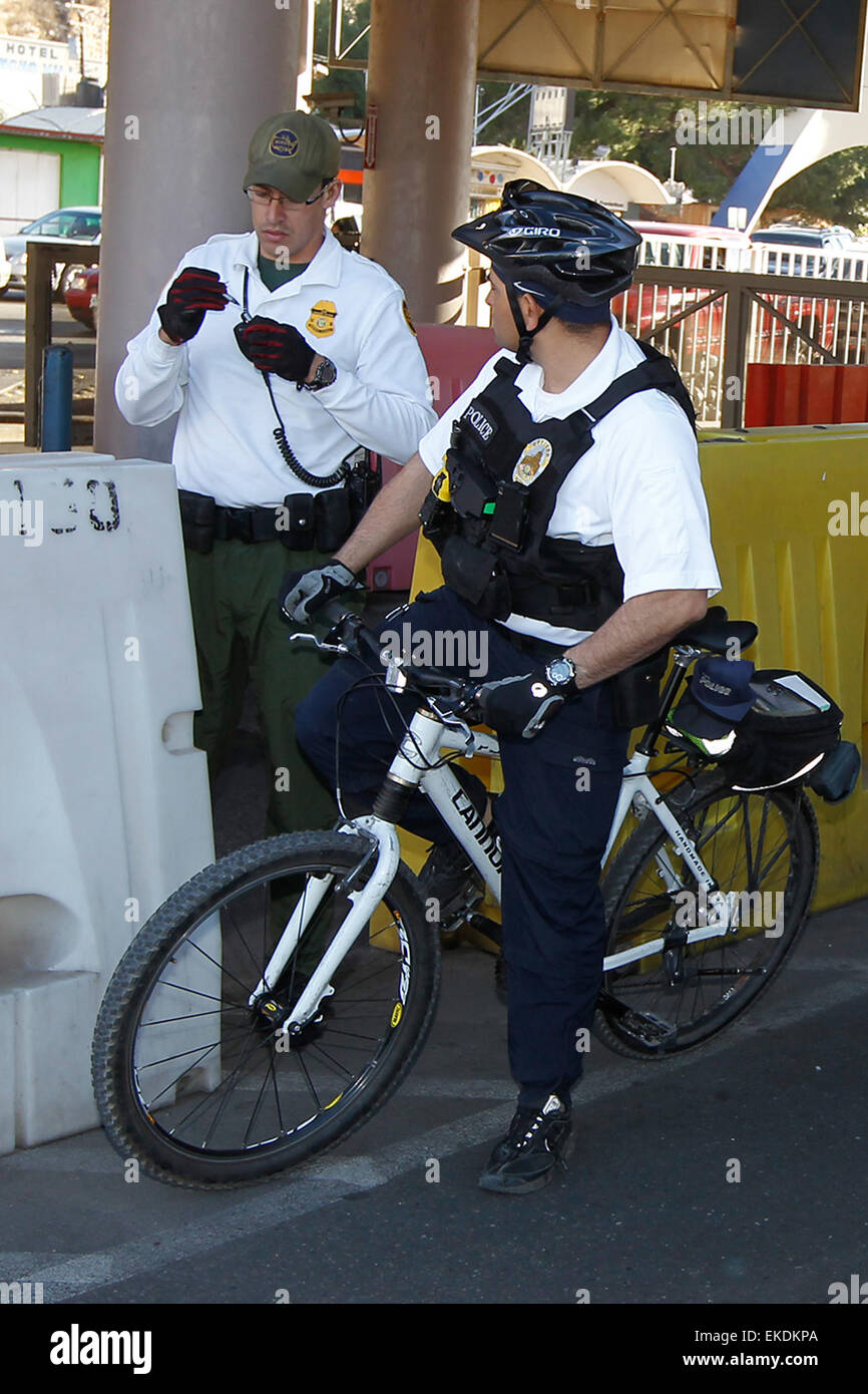 A CBP Border Patrol agent works with local police at the Nogales port ...