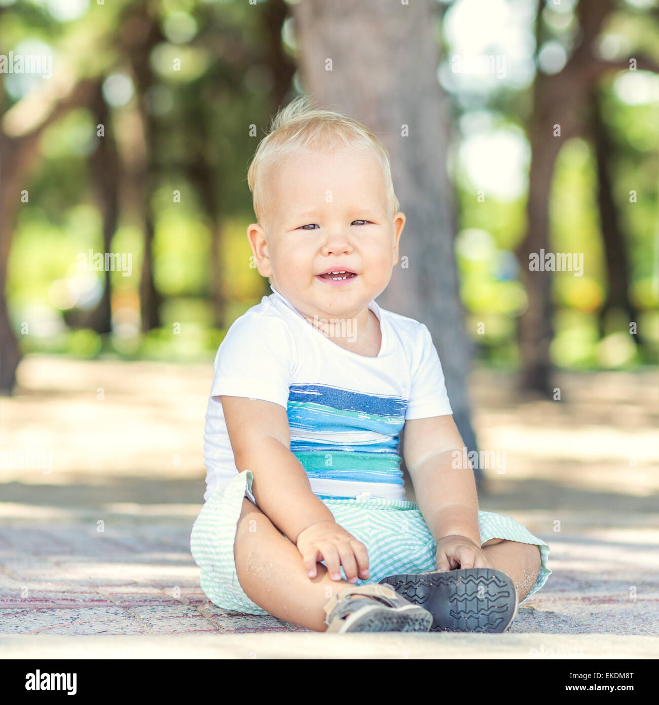 Baby sitting on the path Stock Photo - Alamy