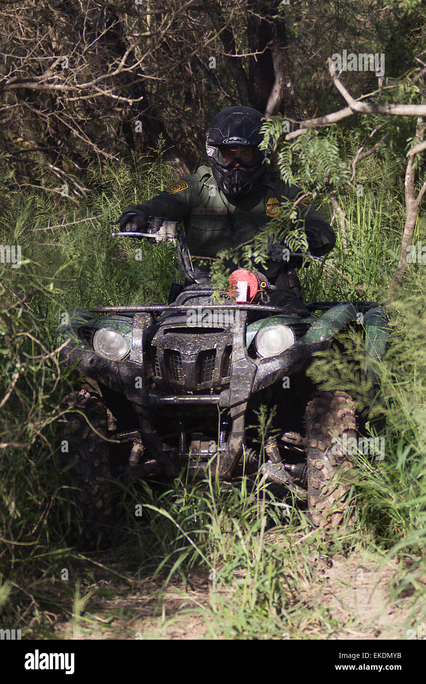A Border Patrol agent patrols the South Texas border on an All Terrain ...