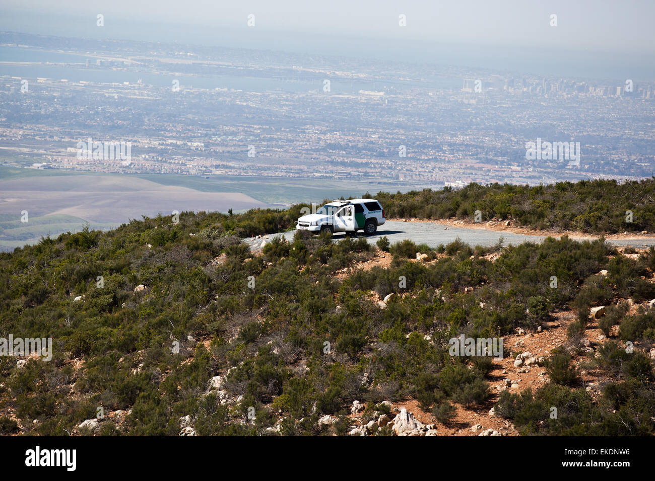 A Border Patrol SUV monitors the U.S.-Mexico border from a vantage ...