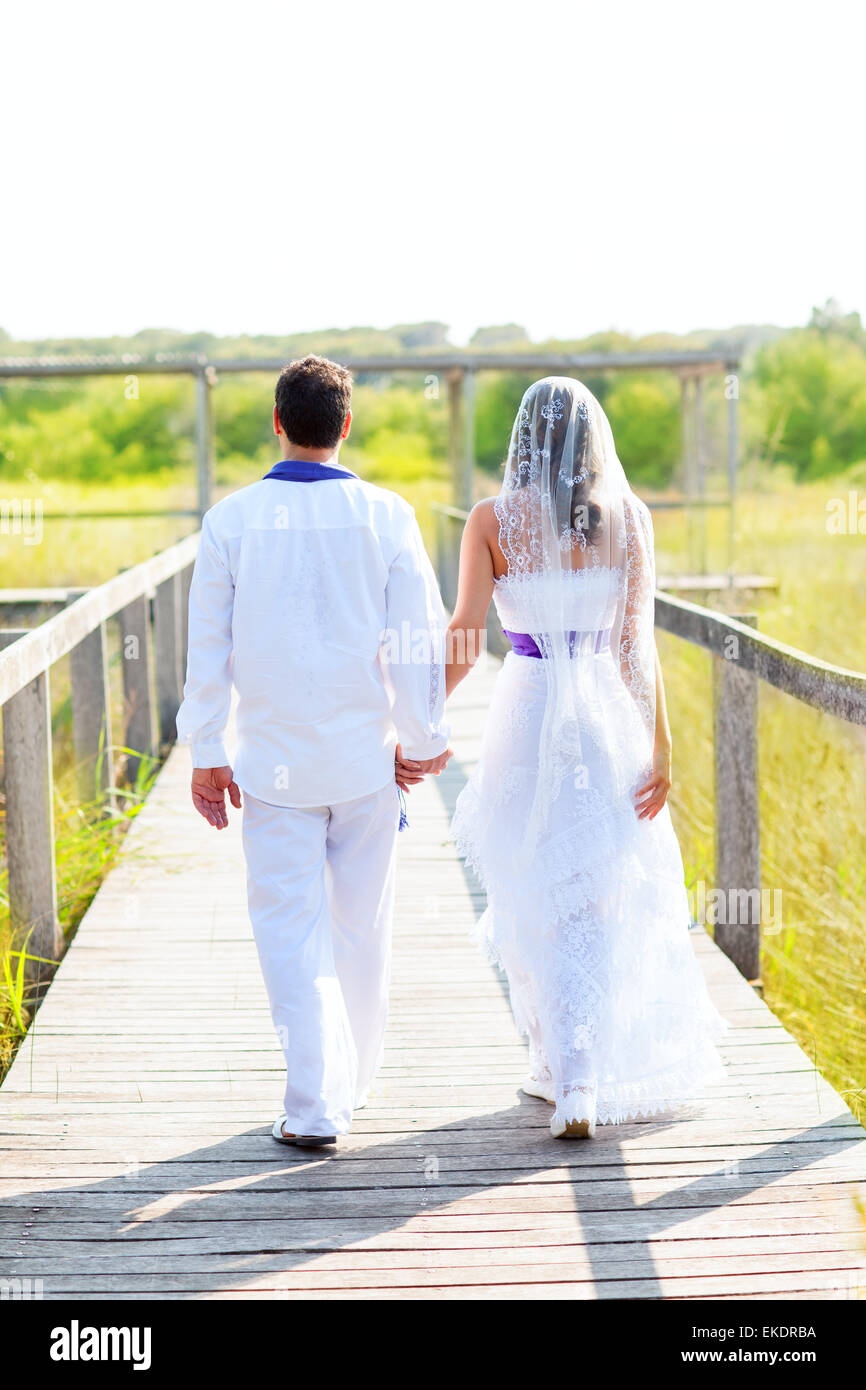 Couple happy in wedding day walking rear view Stock Photo - Alamy