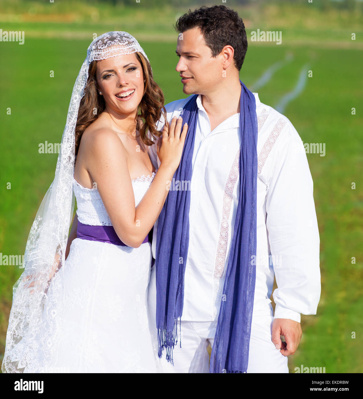 Couple in wedding day hug in green meadow Stock Photo - Alamy