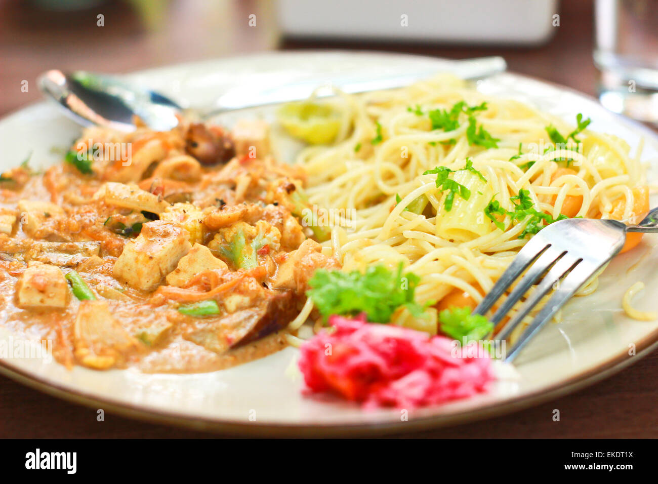vegetarian spaghetti with spoon and fork Stock Photo - Alamy