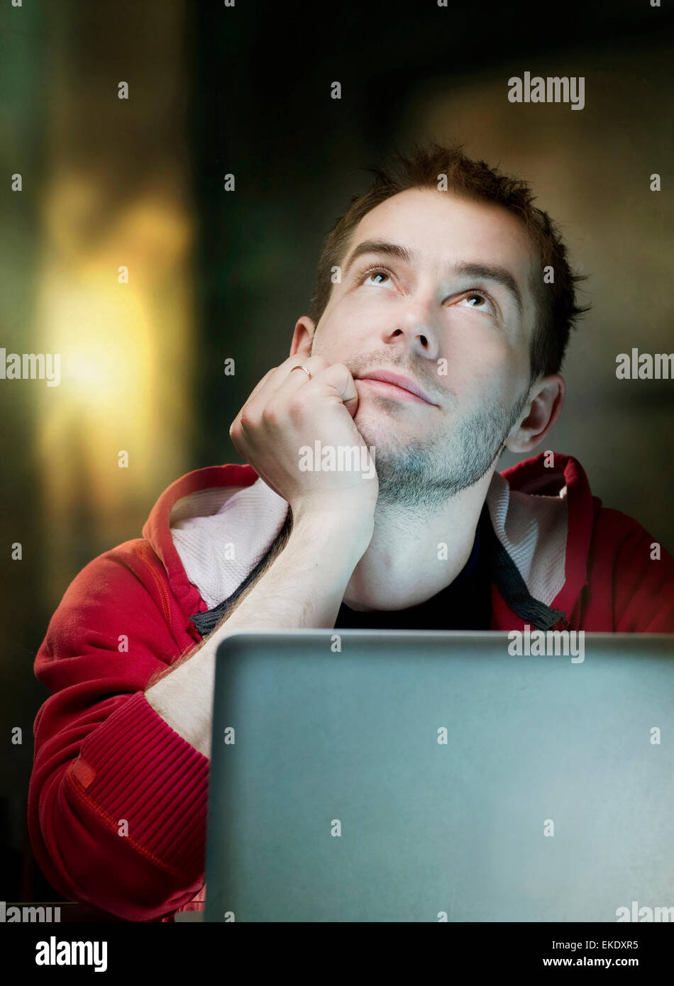 Man With Laptop Thinking Stock Photo - Alamy