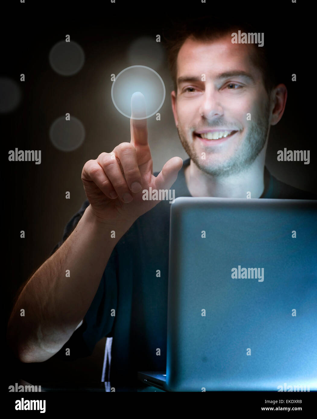 Young Man With Laptop Pushing The Button Stock Photo - Alamy