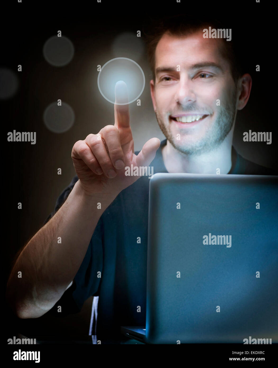 Young Man With Laptop Pushing The Button Stock Photo - Alamy