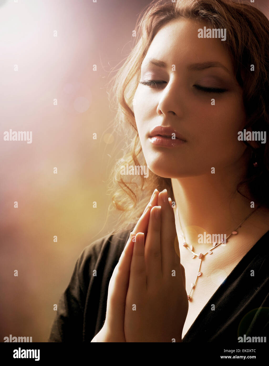 Woman kneeling to pray hi-res stock photography and images - Alamy