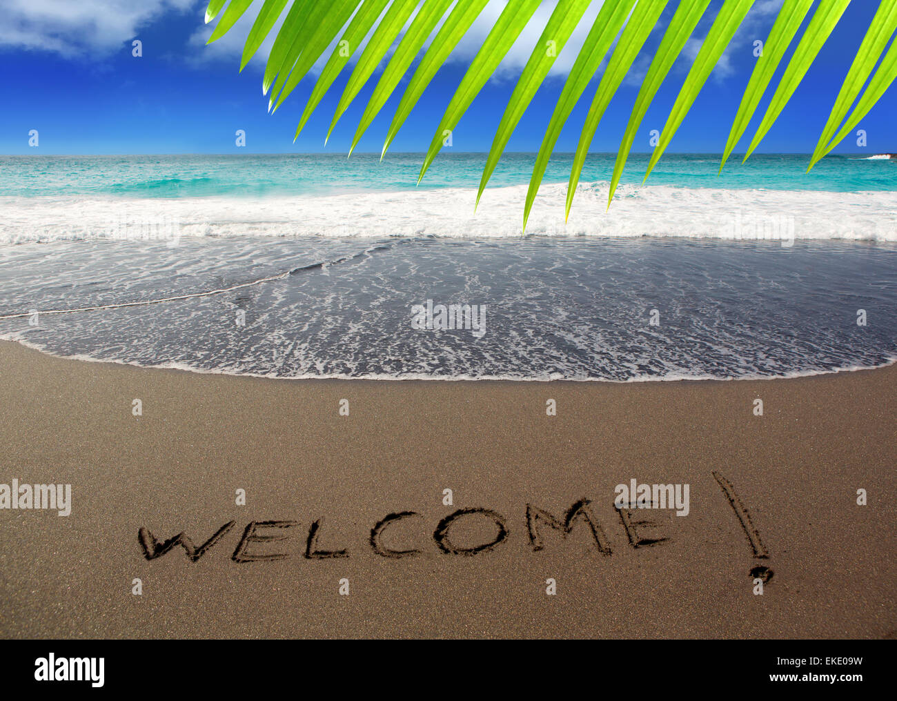 Brown sand beach with written word Welcome Stock Photo - Alamy