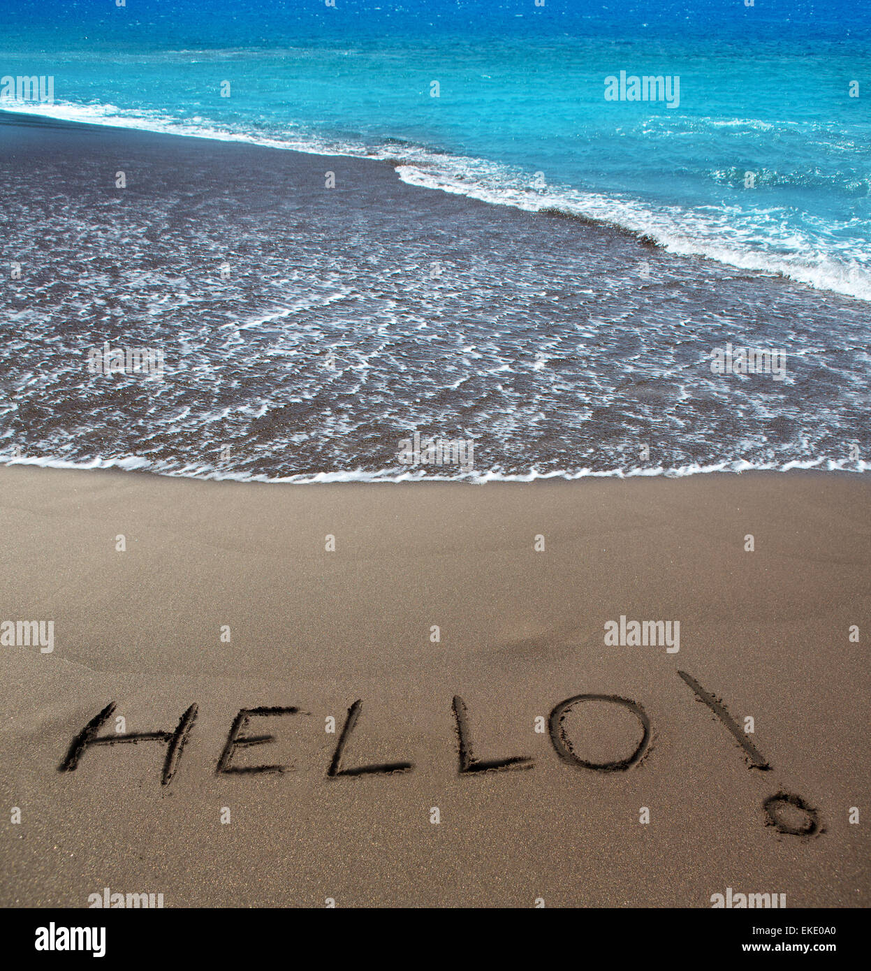 Brown sand beach with written word Hello Stock Photo - Alamy