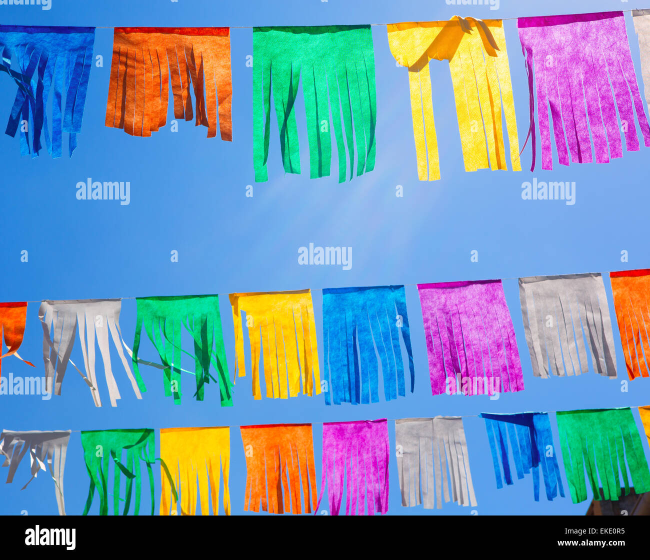 colorful tissue Paper fringe garland under blue sky Stock Photo - Alamy