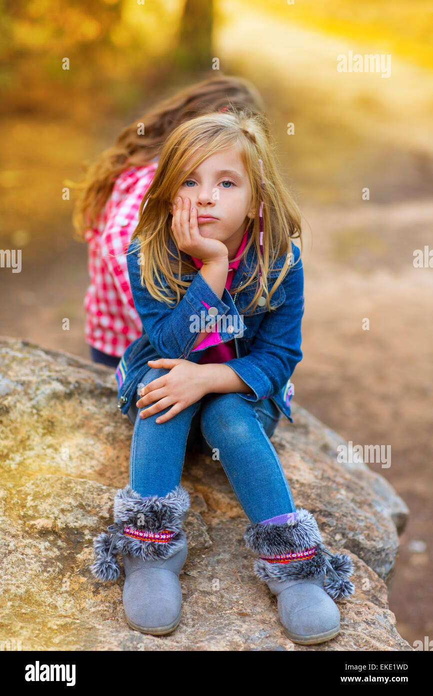 blond kid girl pensive bored in the forest outdoor Stock Photo - Alamy