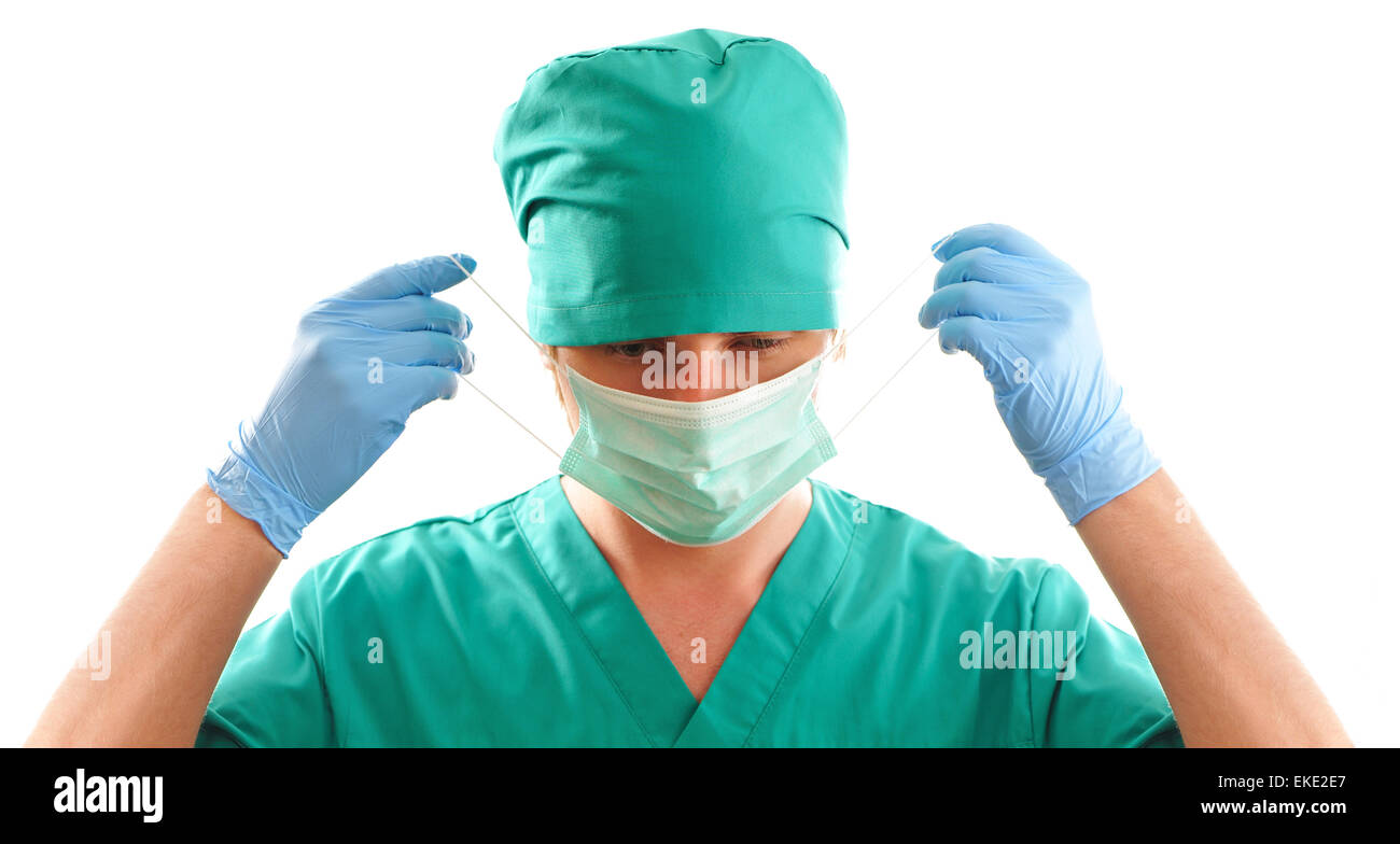 Pulling on surgical mask Stock Photo - Alamy