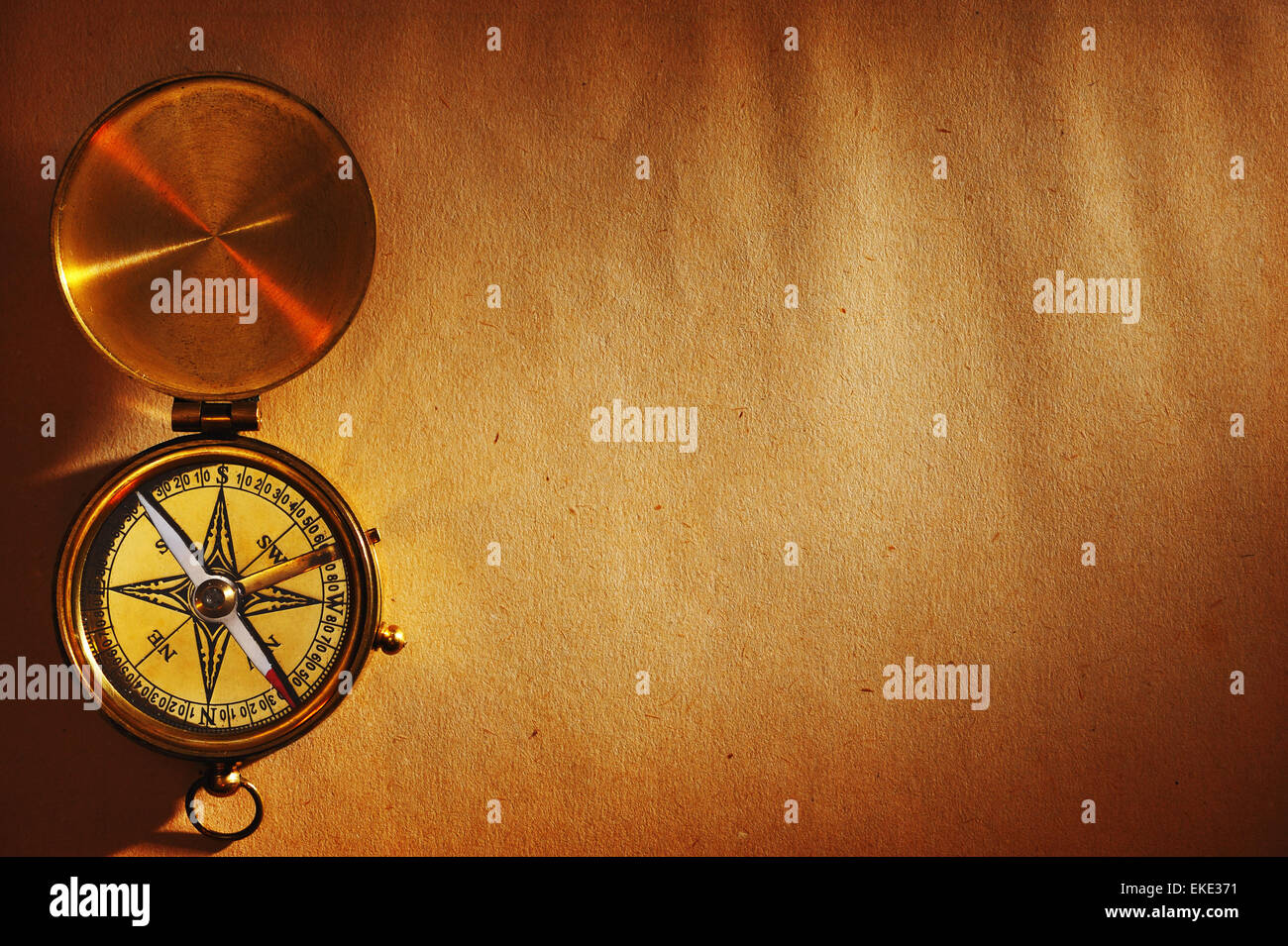 Antique brass compass over old background Stock Photo - Alamy