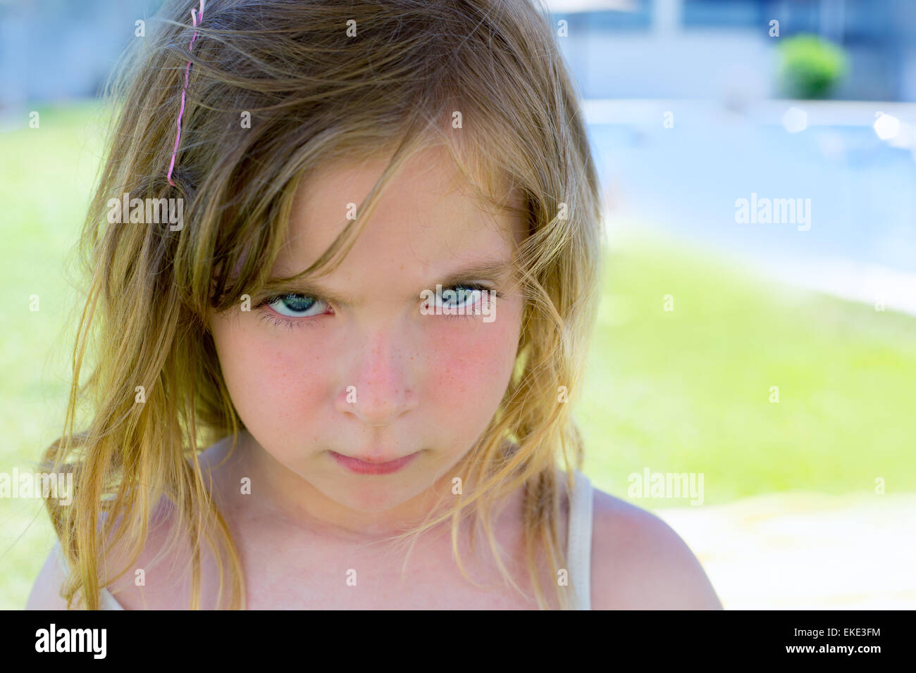 Angry blond children girl portrait looking camera Stock Photo - Alamy