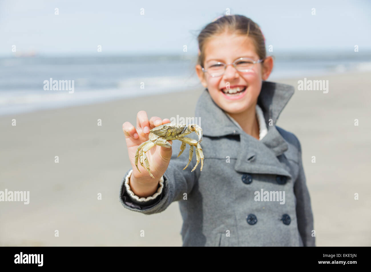 Adorable happy girl holding crab Stock Photo - Alamy