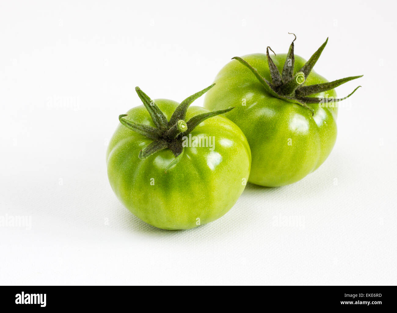 Two fresh green tomatoes isolated on white background with copyspace ...
