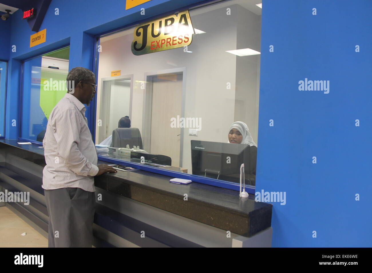 Mogadishu, Somalia. 9th Apr, 2015. A customer waits to collect money ...