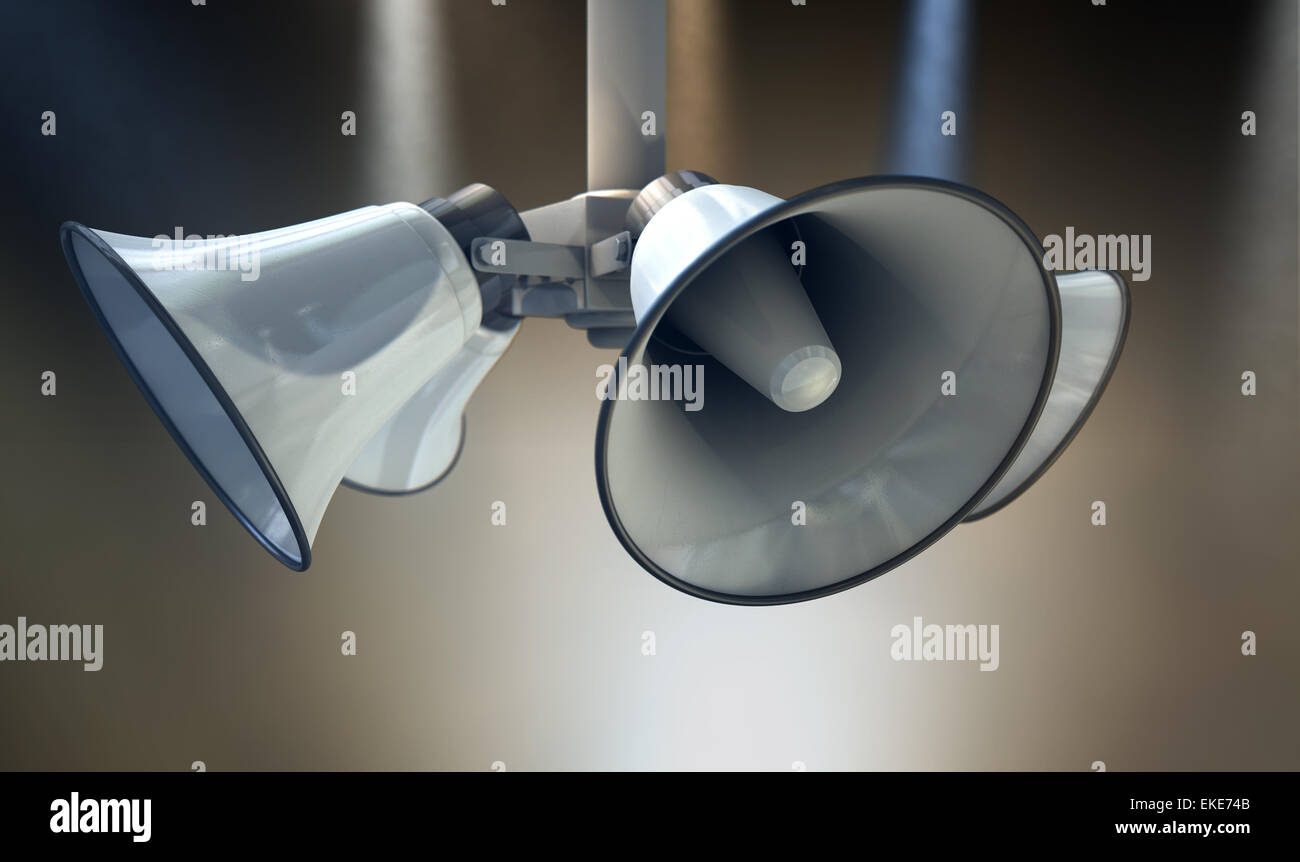 An array of five horn loudspeakers hanging off a pole in a circle ...