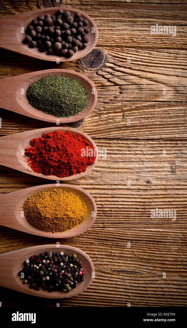 Assorted spices on wooden background Stock Photo - Alamy