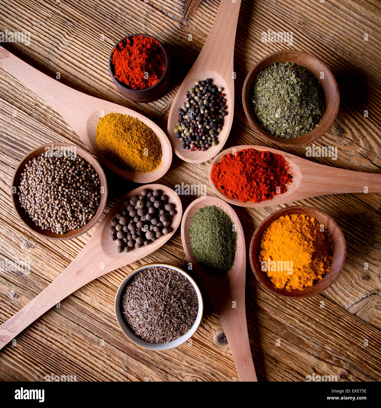 Assorted spices on wooden background Stock Photo - Alamy