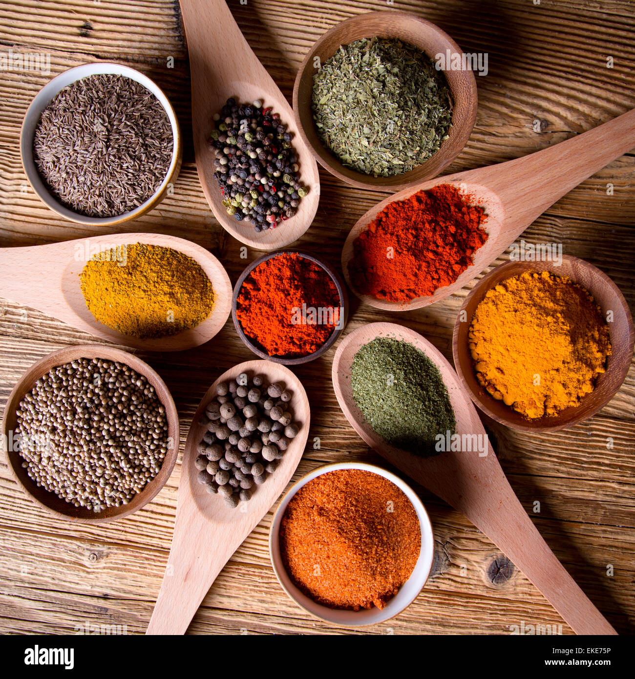 Assorted spices on wooden background Stock Photo - Alamy