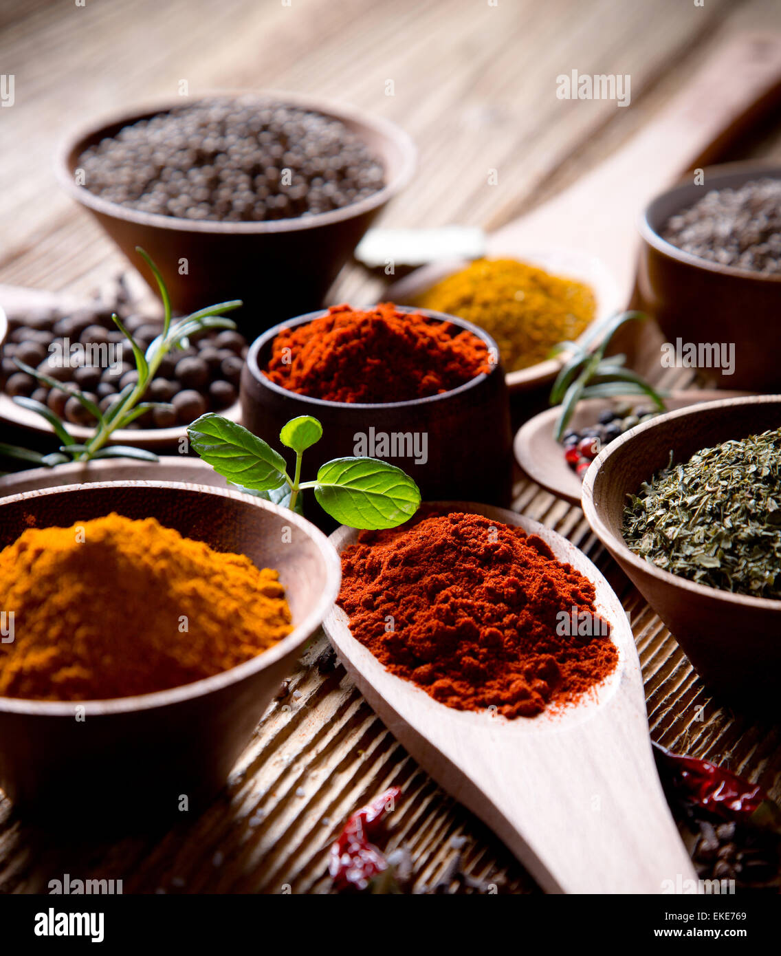 Assorted spices on wooden background Stock Photo - Alamy