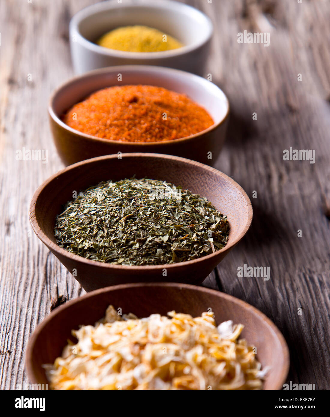 Assorted spices on wooden background Stock Photo - Alamy