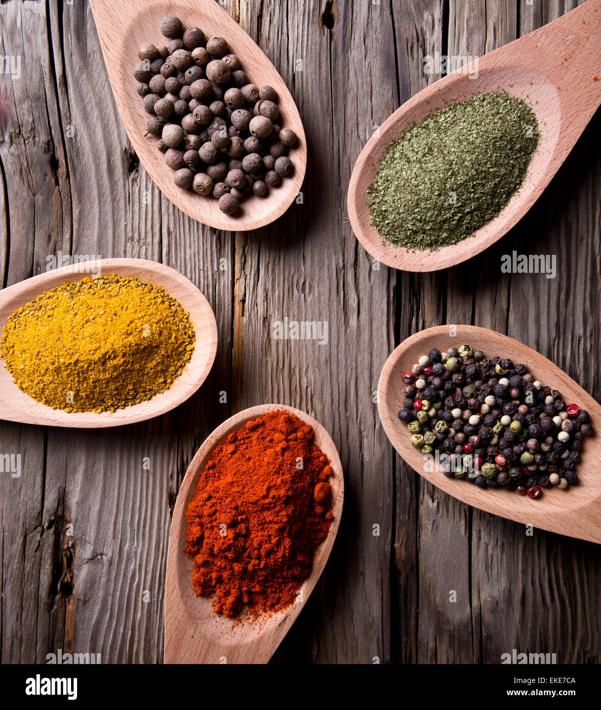 Assorted spices on wooden background Stock Photo - Alamy