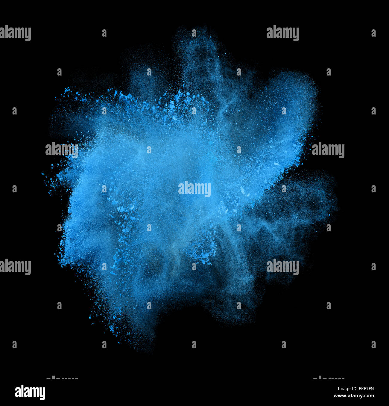 Freeze motion of blue powder exploding, isolated on black. Abstract ...