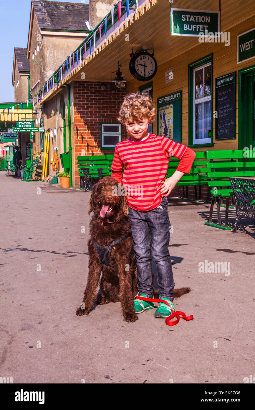 Five year old boy with his pet Labradoodle dog, Alresford Station ...