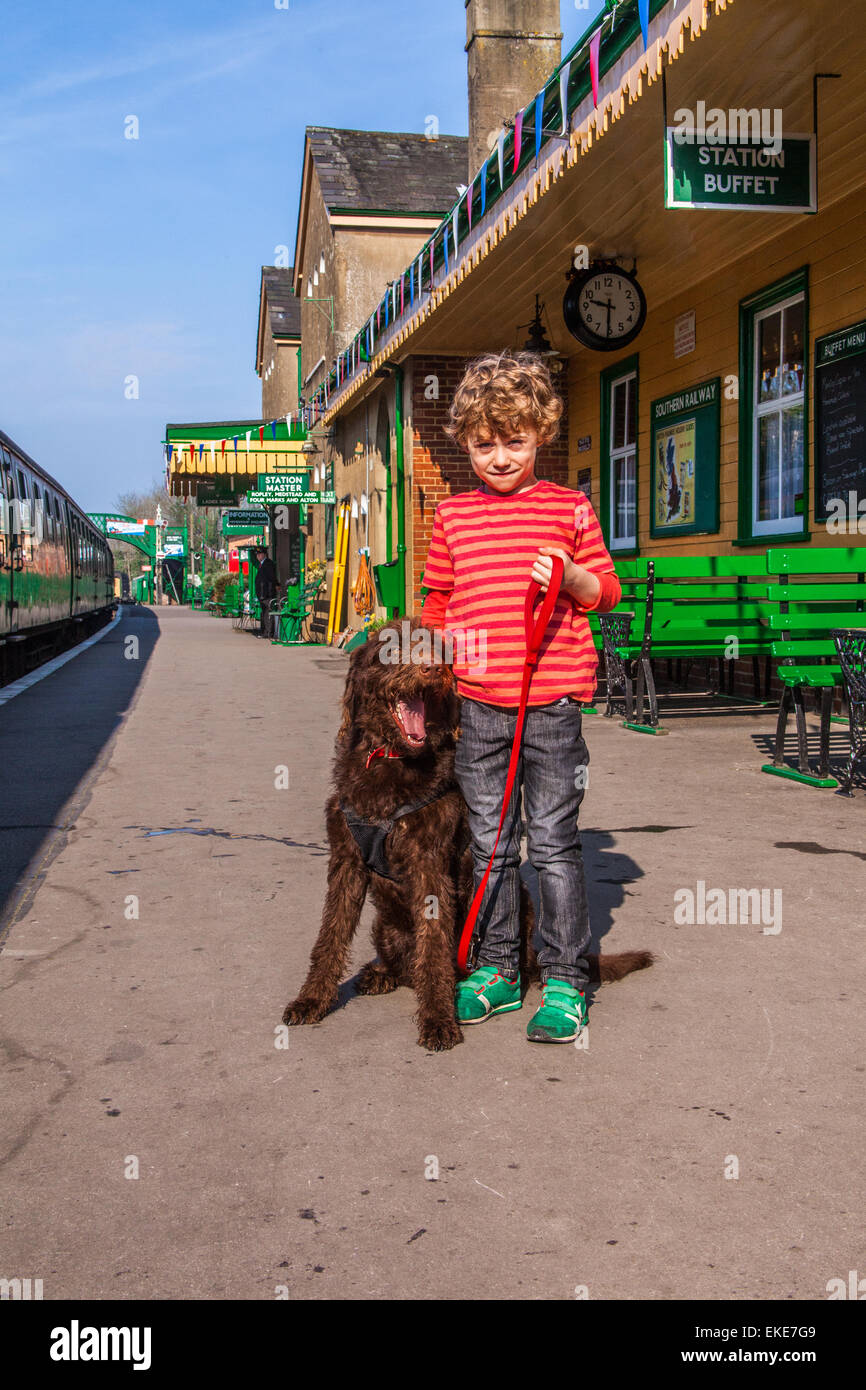Five year old boy with his pet Labradoodle dog, Alresford Station ...