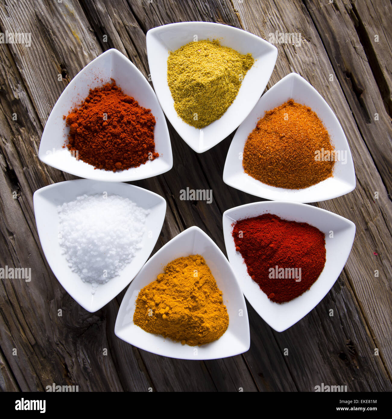 Assorted spices on wooden background Stock Photo - Alamy