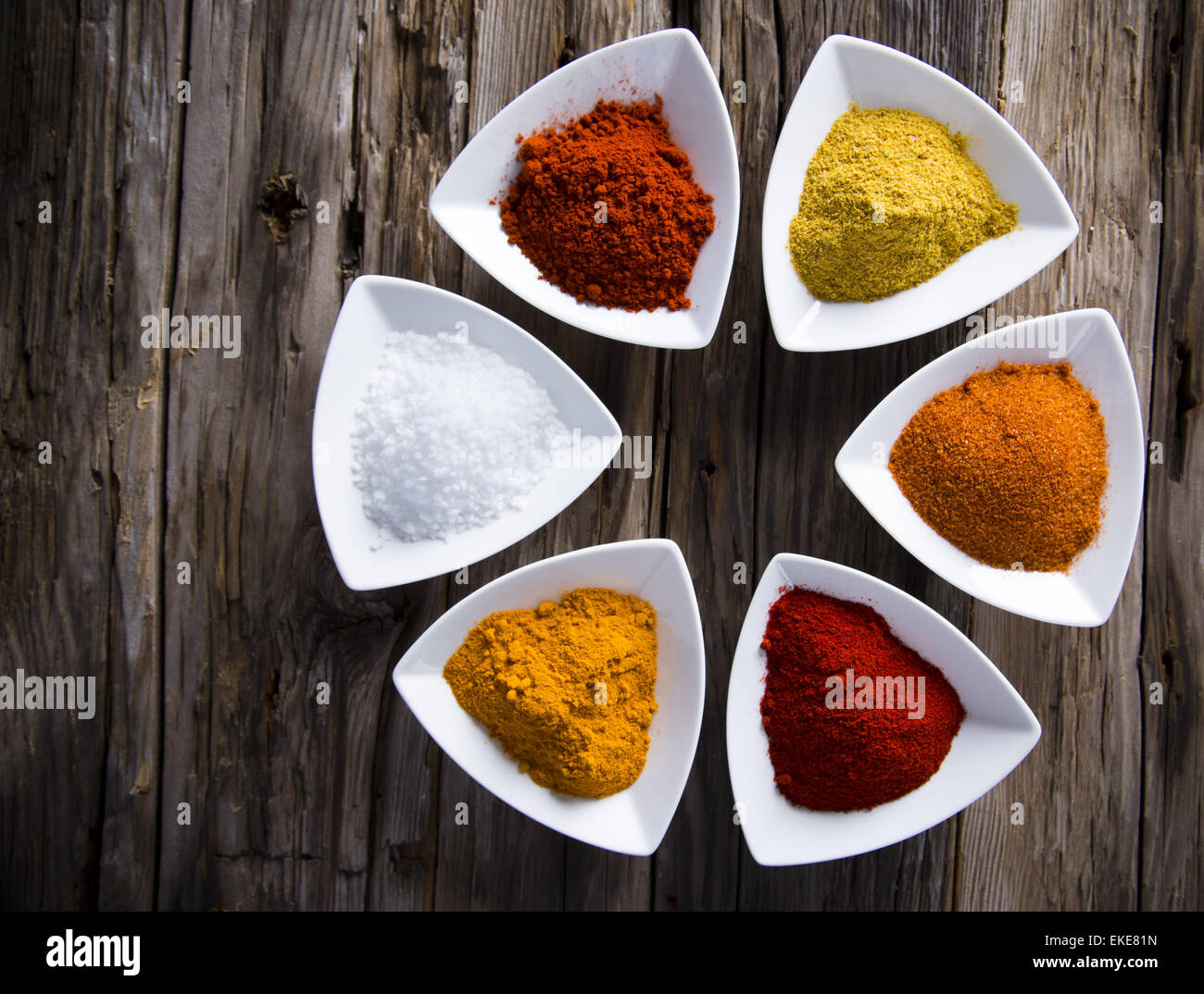 Assorted spices on wooden background Stock Photo - Alamy