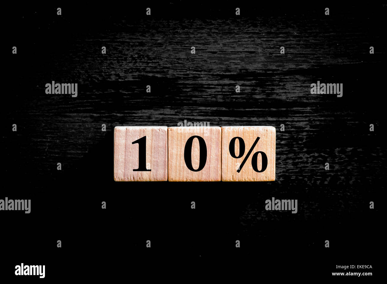 Ten percent symbol. Wooden small cubes with letters isolated on black ...