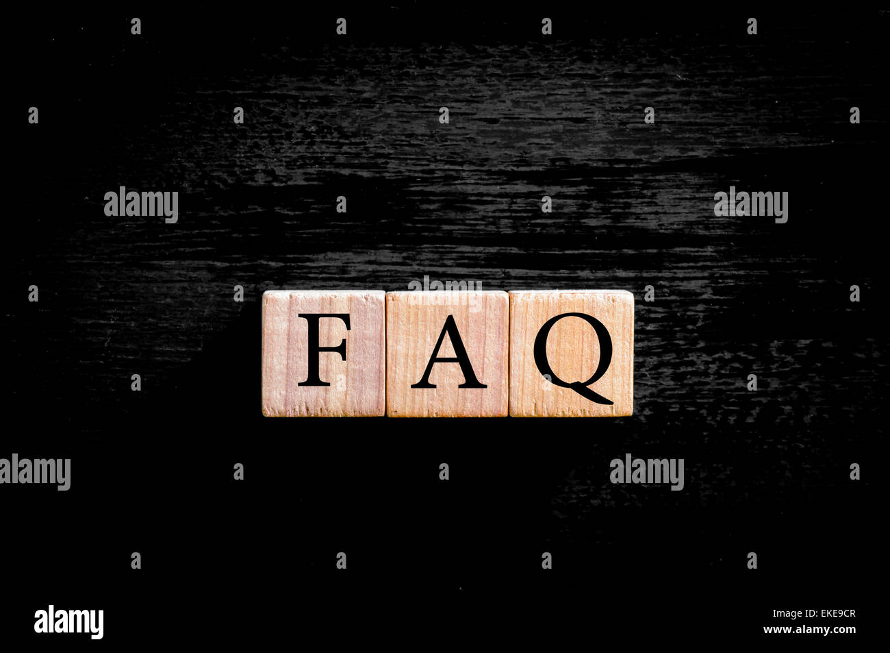 Acronym FAQ - frequently asked questions. Wooden small cubes with ...