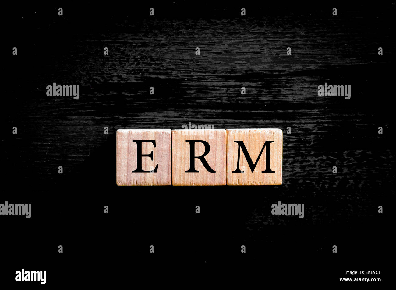 Acronym ERM - enterprise risk management. Wooden small cubes with ...