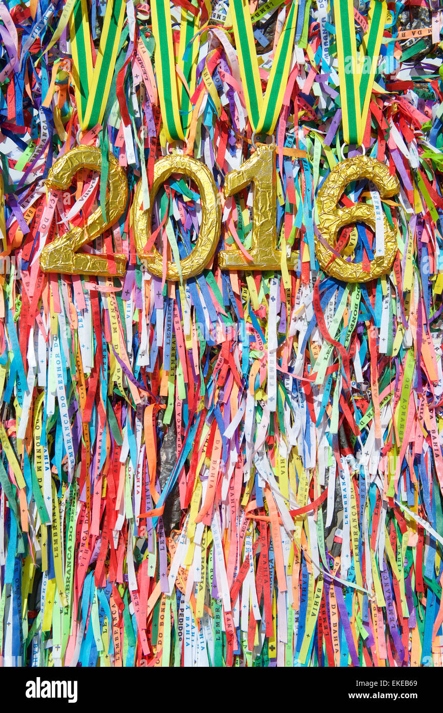 Gold medal 2016 hanging from ribbons on wall of colorful good luck ...