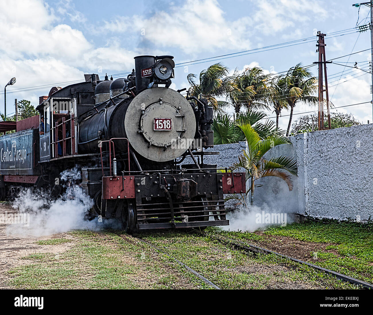 Old American steam train with steam coming out of the wheels and the ...