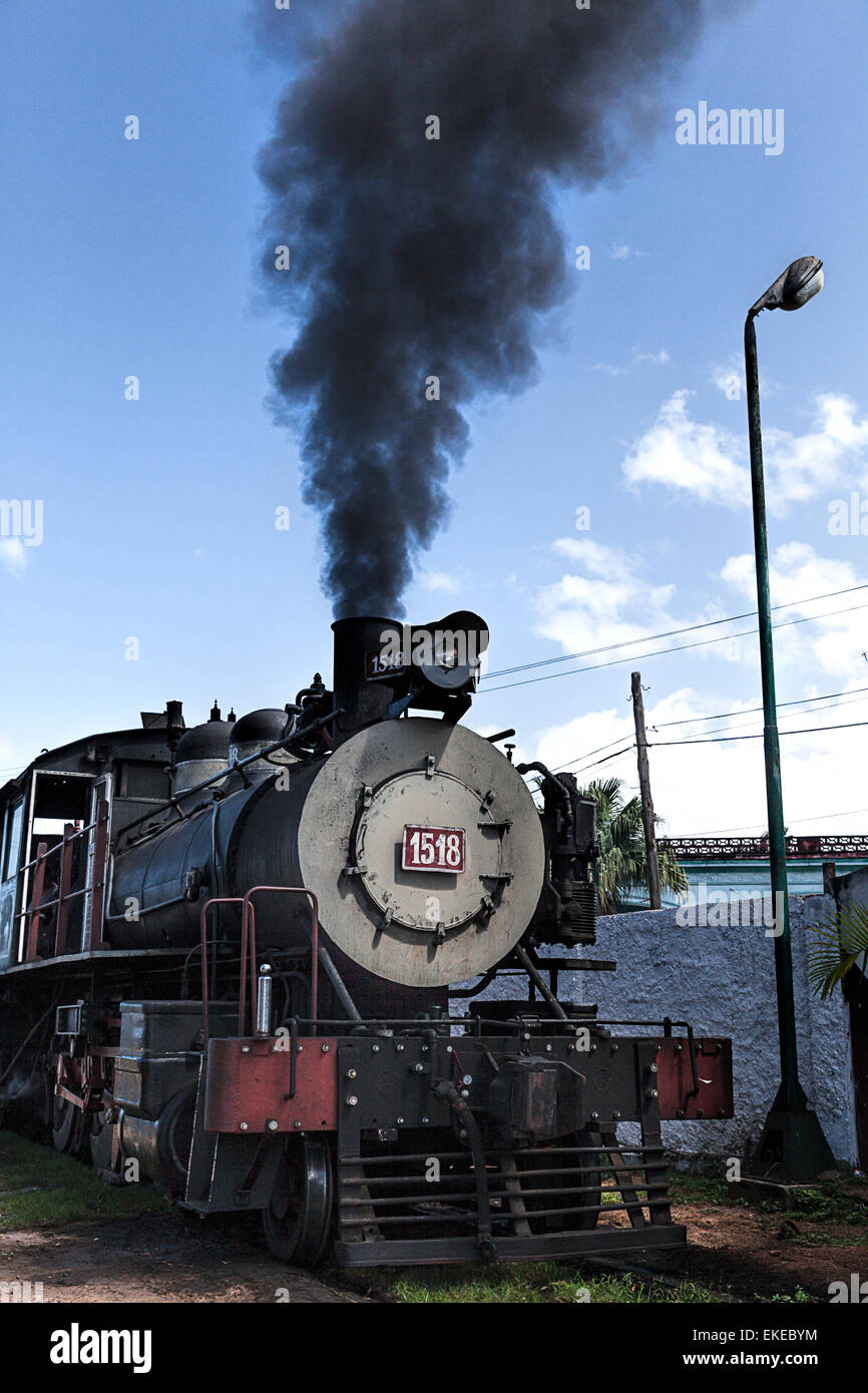 Old American steam train in Cuba with thick black smoke coming out of ...