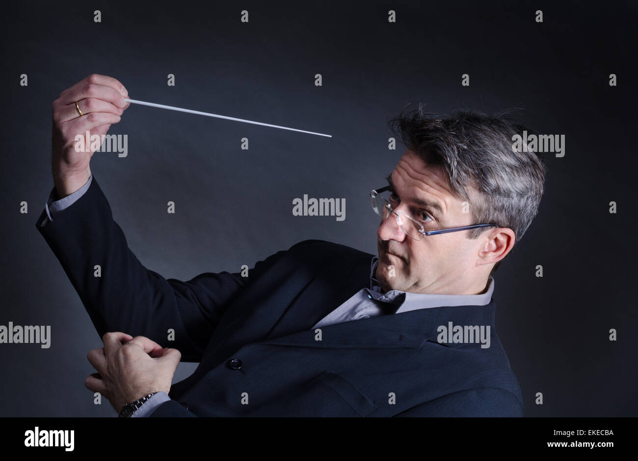 Conductor with a mad expression fidgeting with his baton Stock Photo ...