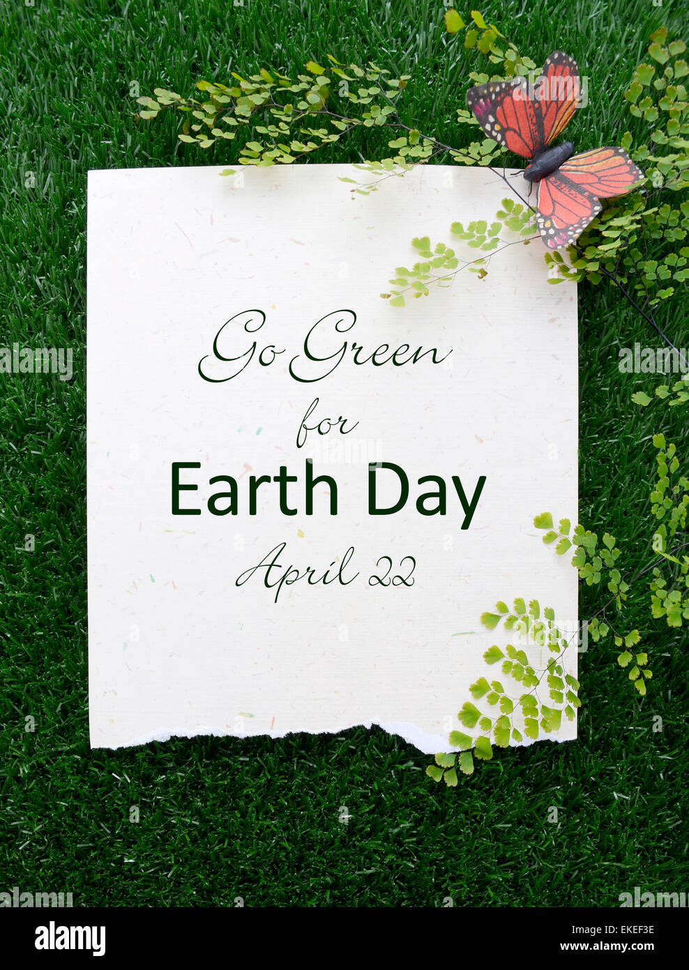 Earth Day, April 22, Concept with recycled paper in grass with fern and ...