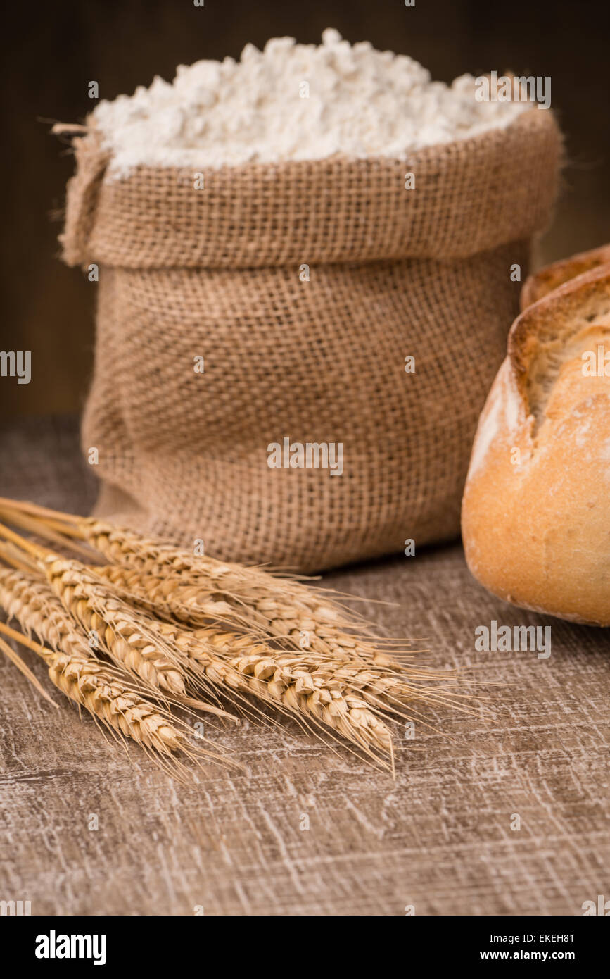 Rustic bread and wheat on an old vintage planked wood table Stock Photo ...
