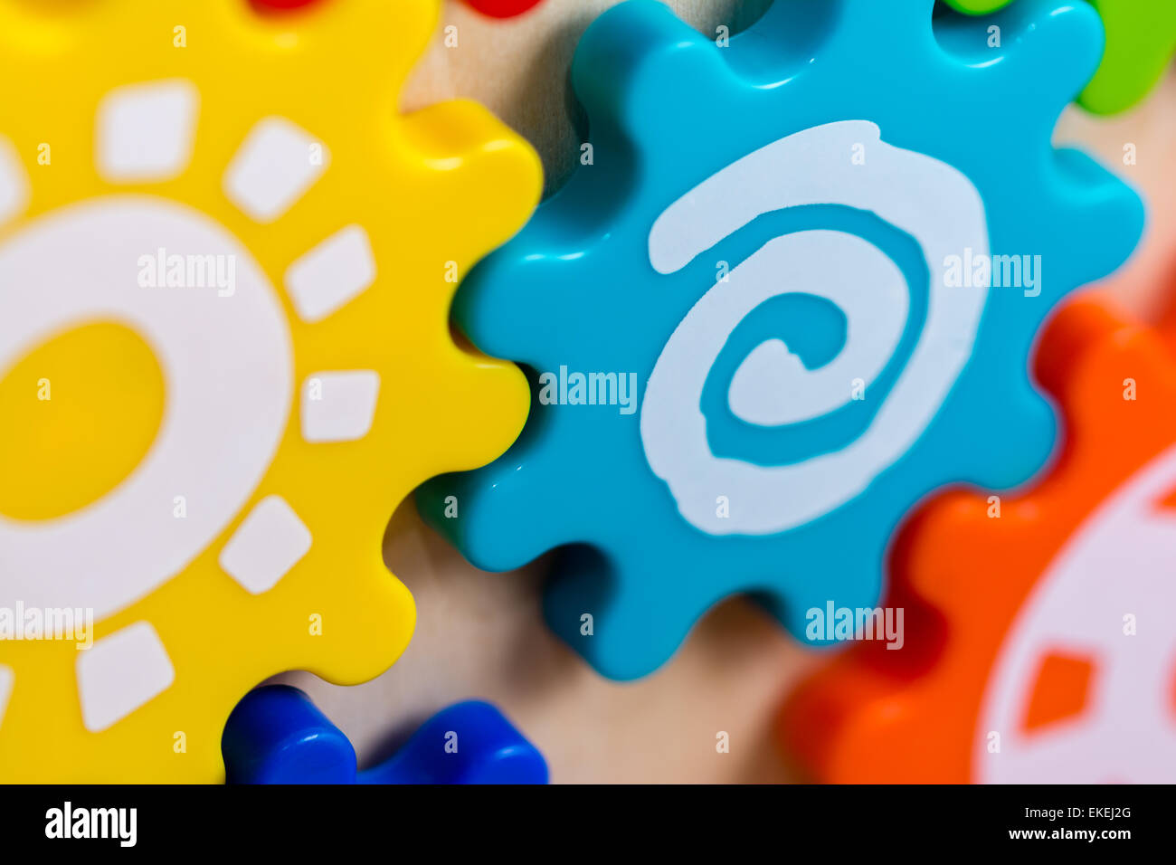 Colorful plastic gears from a children's toy with different white ...